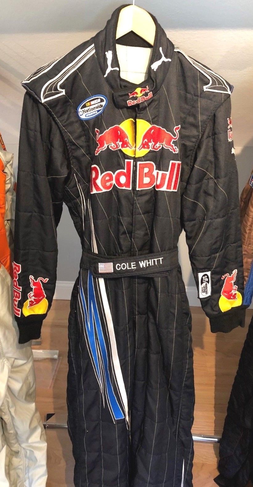 COLE WHITT,RED BULL RACING, RACE USED/WORN, 2010 NATIONWIDE PUMA ...